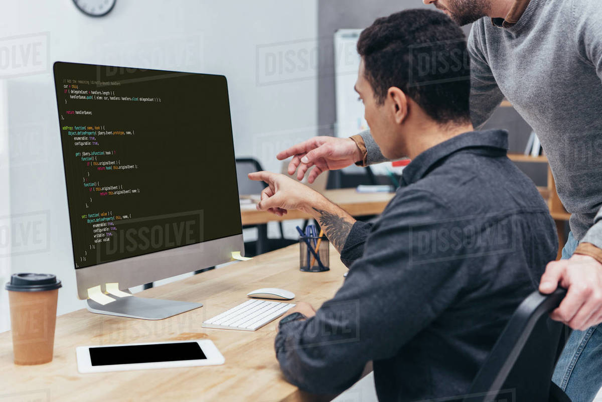 cropped shot of business colleagues using desktop computer with html ...