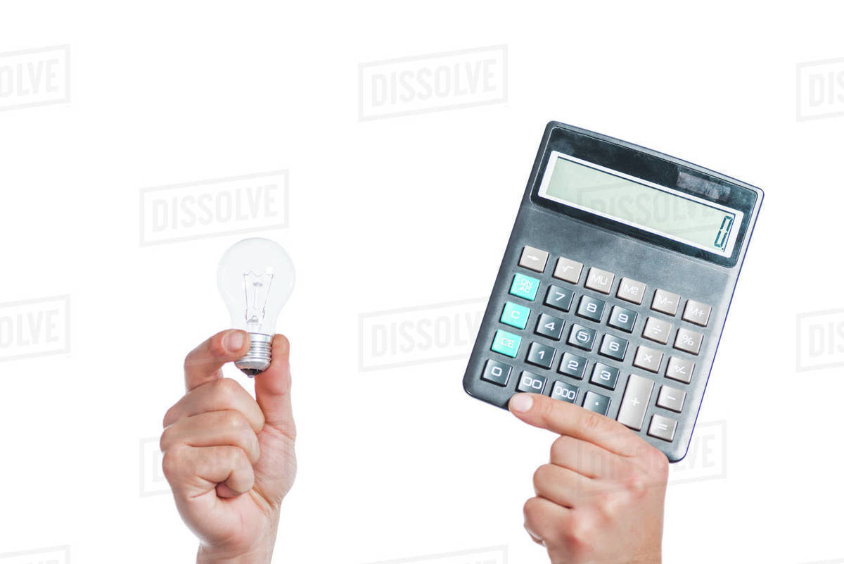 Cropped view of male hands holding led lamp and calculator in hands ...