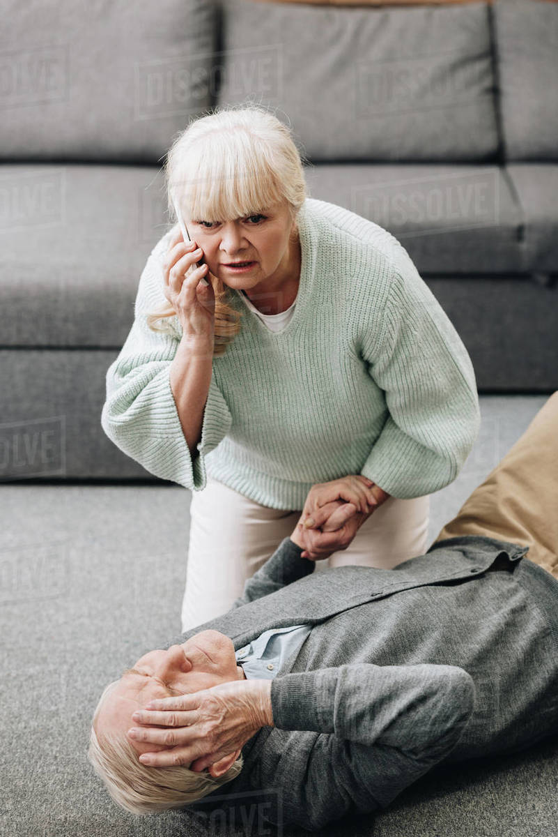 Senior woman helping old husband who fell down on floor - Royalty-free ...