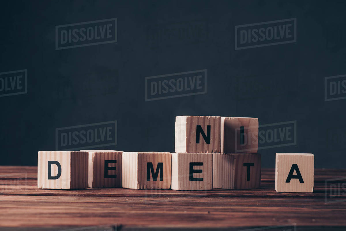 Wooden cubes with dementia letters on table on black background ...
