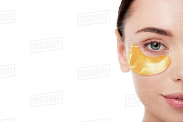 Cropped view of beautiful woman with golden eye patch isolated on white ...