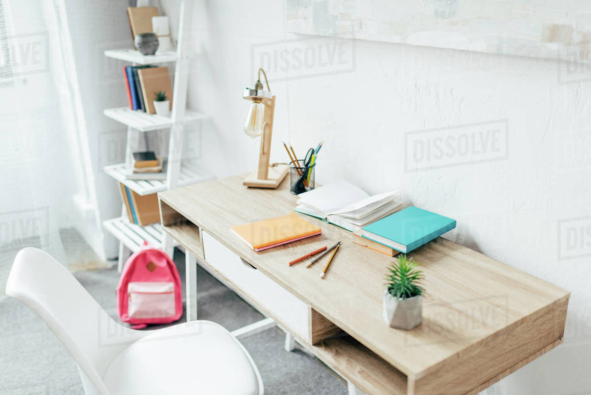 Minimalistic room interior with writing desk and school supplies placed ...