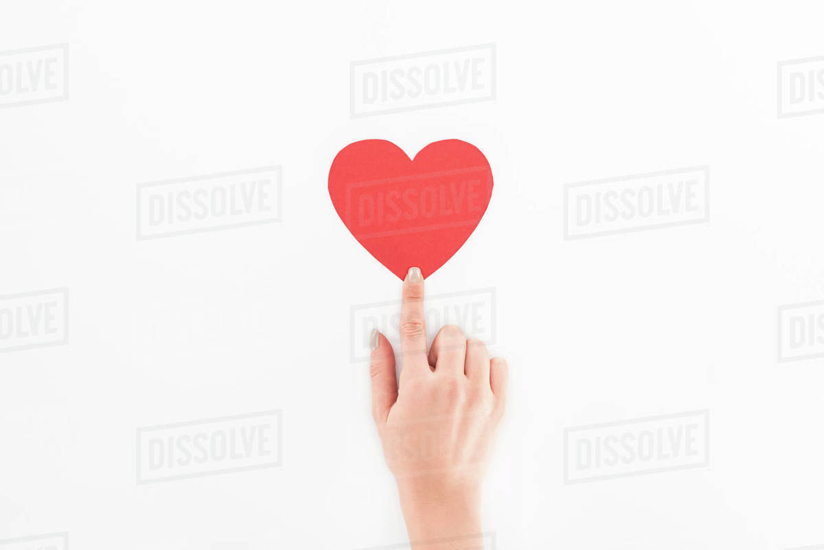 Cropped shot of woman pointing at red heart symbol isolated on white ...