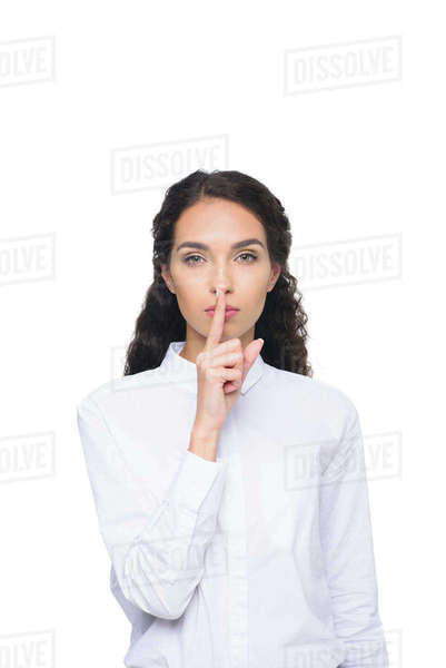 Brunette woman in white shirt showing silence symbol, isolated on white ...