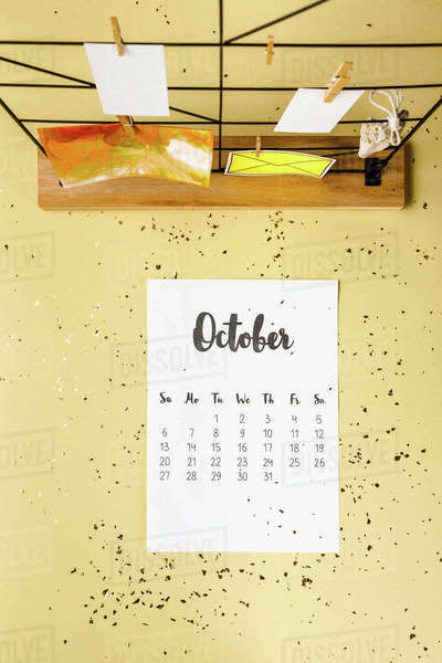 Top view of October calendar with golden confetti and cards with ...
