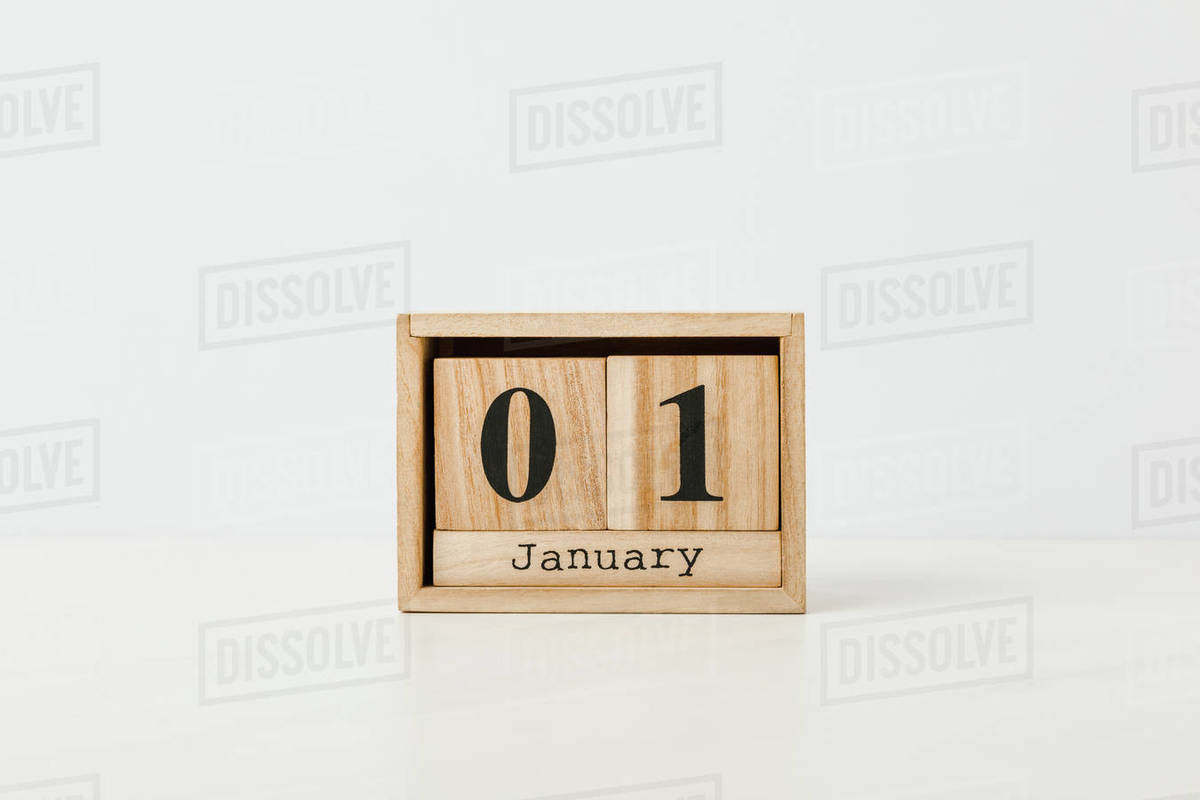 Close-up view of wooden calendar with 01 January on white background ...