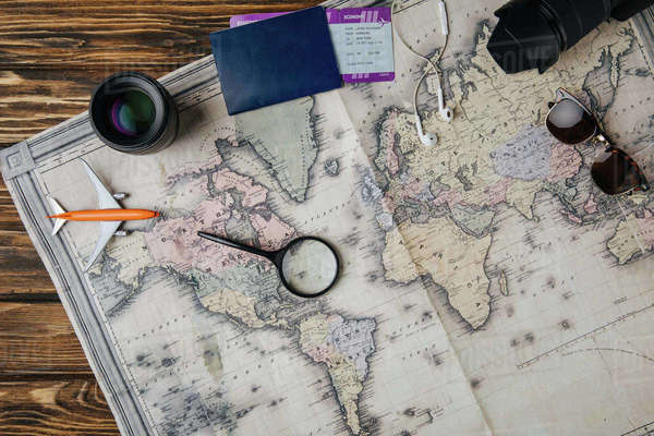 Top view of magnifying glass, small model plane, sunglasses, photo ...