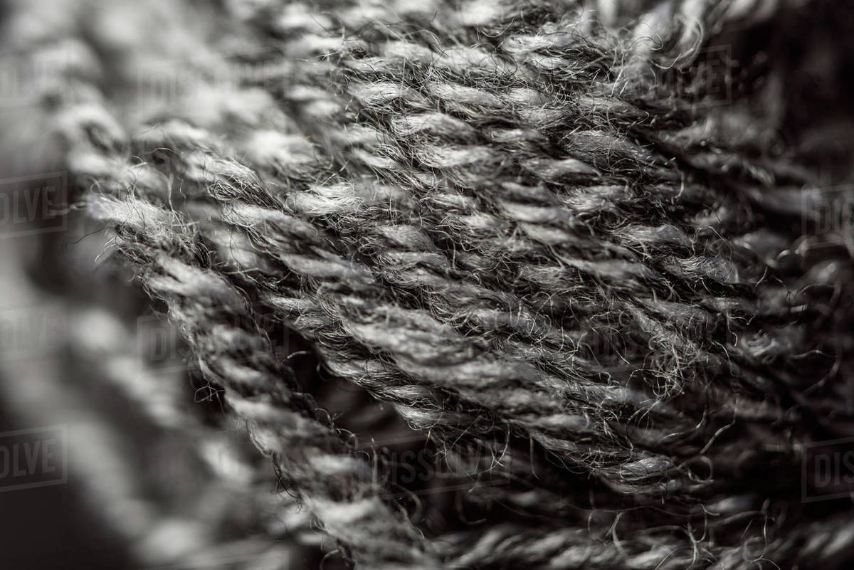 Full frame of grey yarn texture as background - Stock Photo - Dissolve