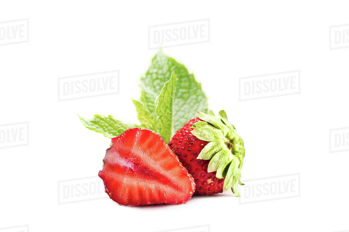Whole and half ripe strawberries with mint leaves isolated on white ...