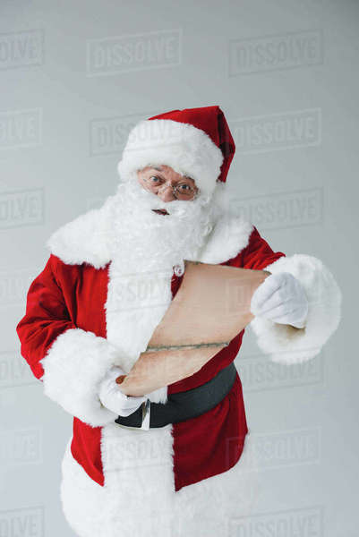 santa claus with wish list and looking at camera - Royalty-free Stock ...