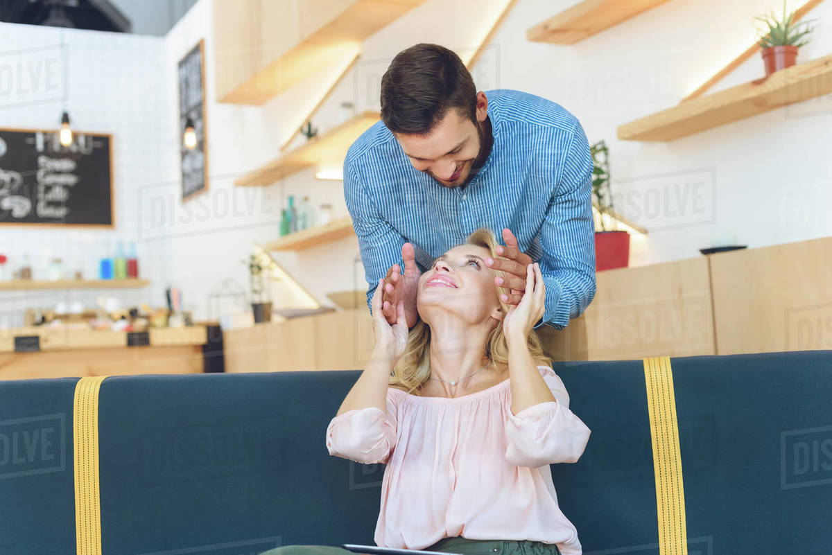 Happy young couple smiling each other in cafe - Royalty-free Stock ...