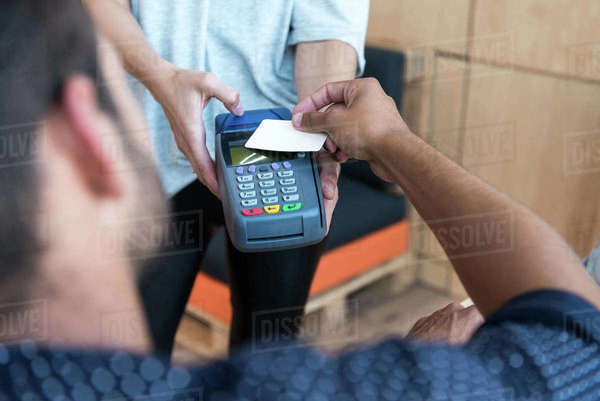 Selective focus of payment by credit card and terminal in cafe ...
