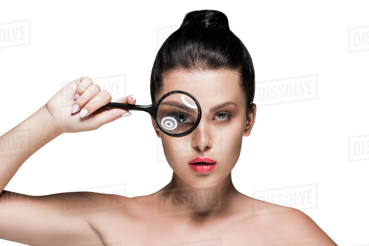 Attractive young woman with magnifying glass isolated on white ...