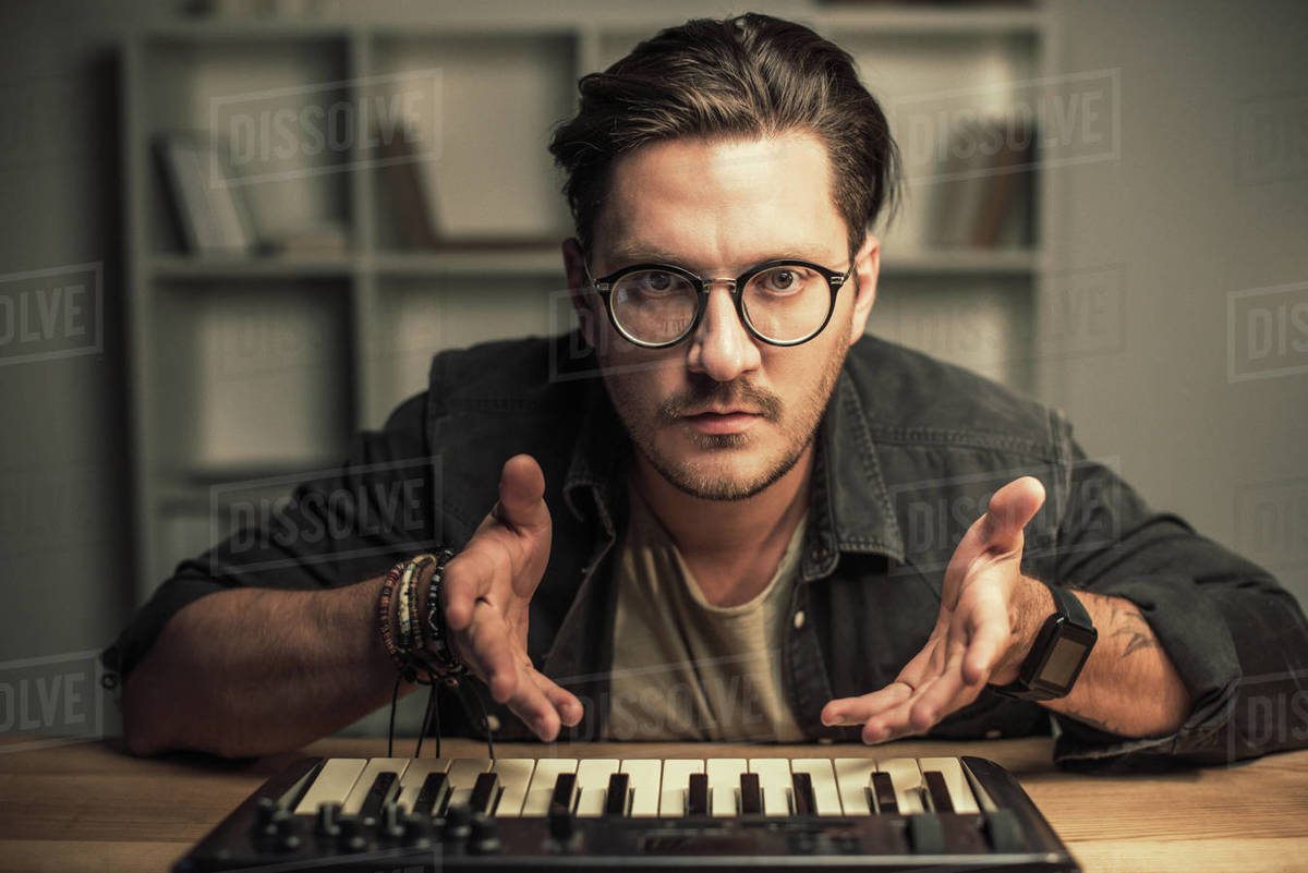 Handsome young man with keyboard controller - Royalty-free Stock Photo ...