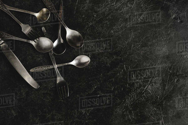 Top view of set of vintage silverware isolated on black table - Royalty ...