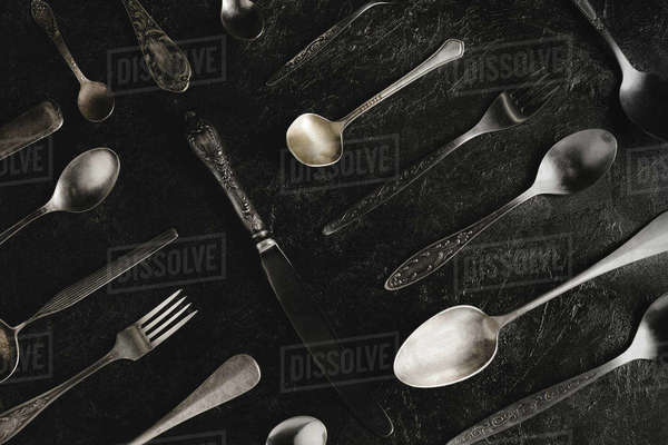 Top view of set of vintage silverware isolated on black table - Royalty ...