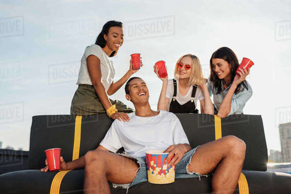 Group of young women flirting with handsome man on party - Royalty-free ...