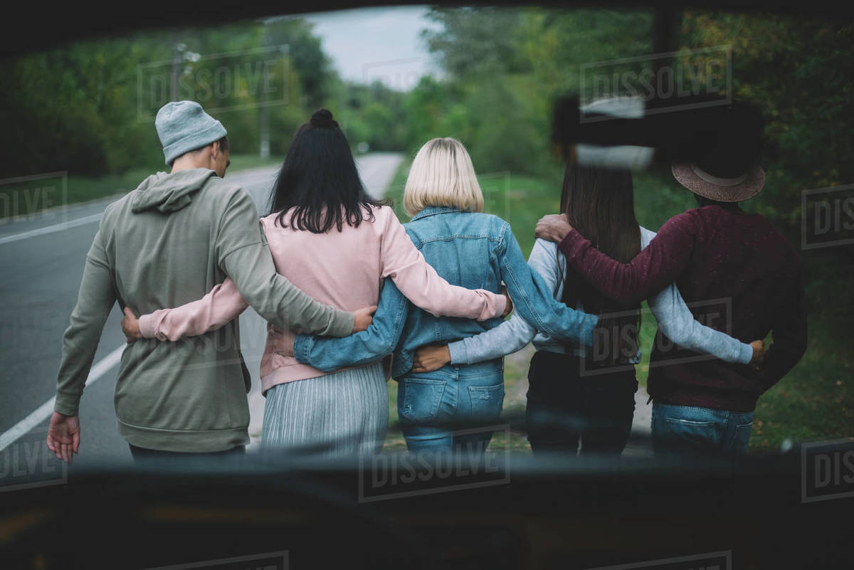 Back view of friends hugging and walking together - Royalty-free Stock ...