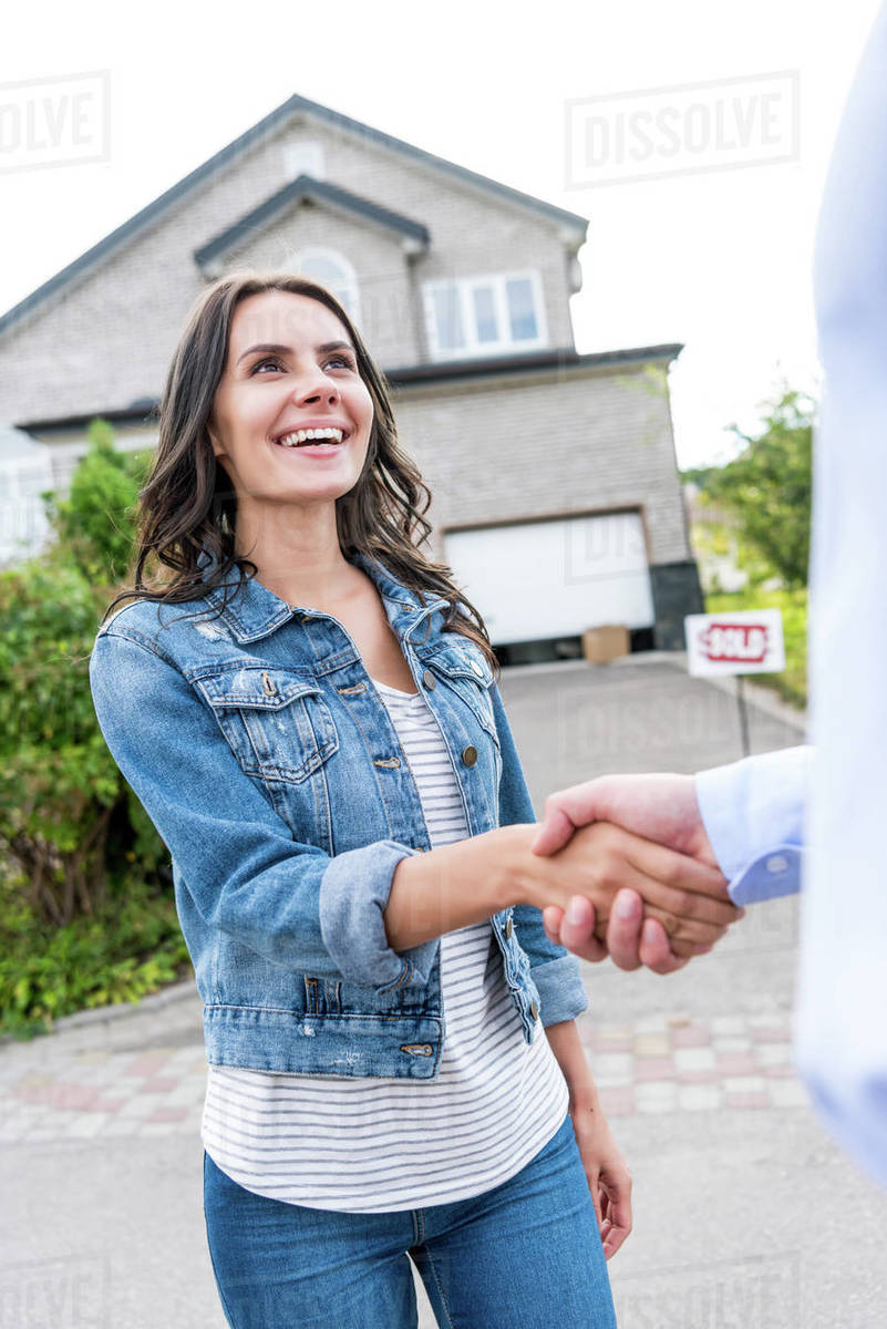 Young happy woman shaking hands with realtor - Royalty-free Stock Photo ...