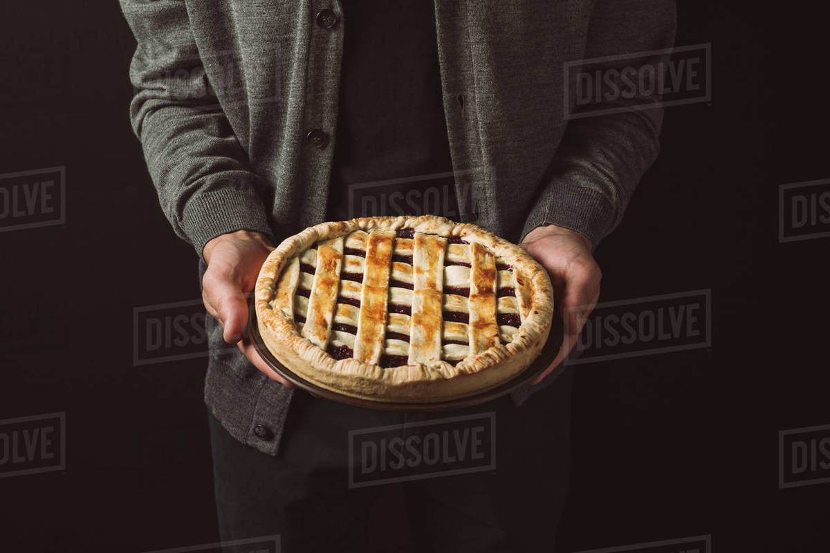 Partial view of man holding homemade pie in hands - Royalty-free Stock ...