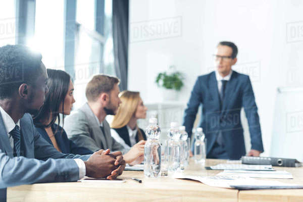 Businesspeople having conversation in conference hall - Royalty-free ...