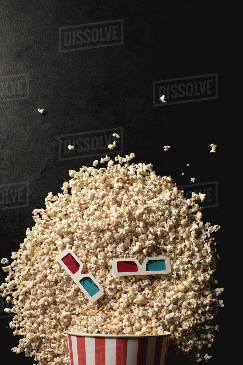 Top view of spilled popcorn with 3d glasses on black - Royalty-free ...
