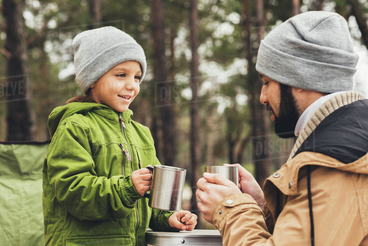 happy father and his little son with cups of tea outdoors - Royalty ...