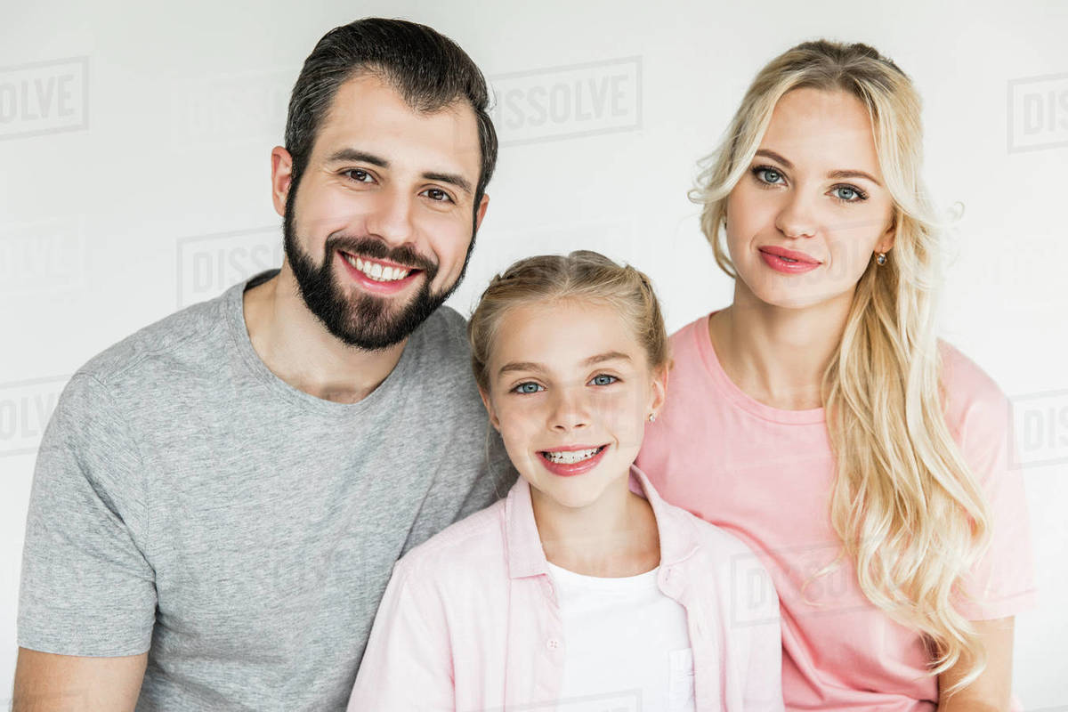 Happy family with one kid smiling at camera isolated on white - Royalty ...