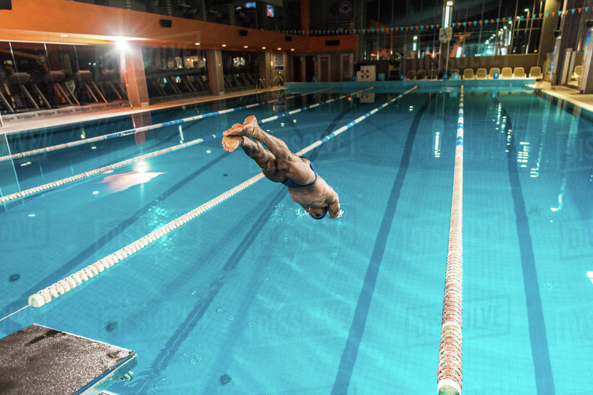 Swimmer diving into competition swimming pool - Royalty-free Stock ...