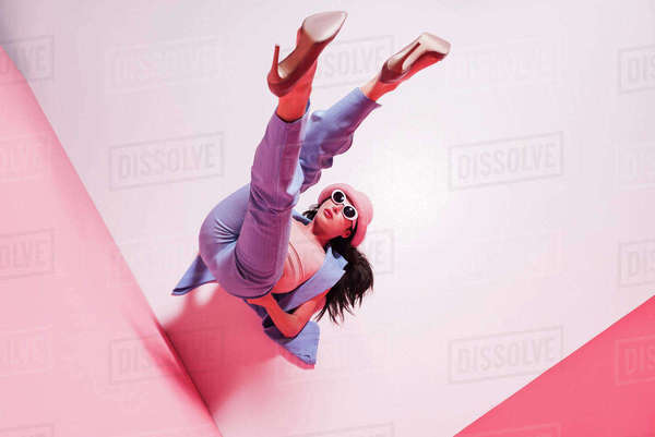 Stylish girl in high heeled shoes posing upside down in studio - Stock ...
