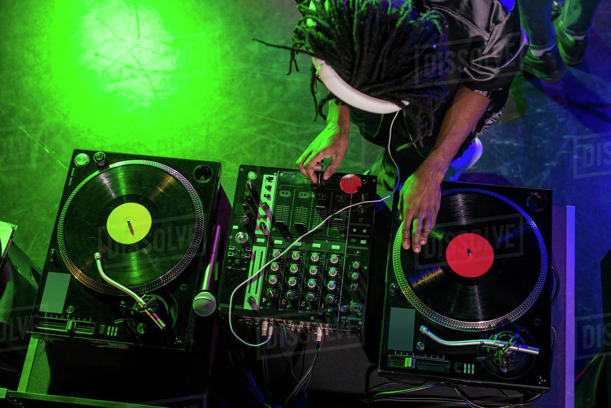 Overhead view of professional African American dj in headphones with ...