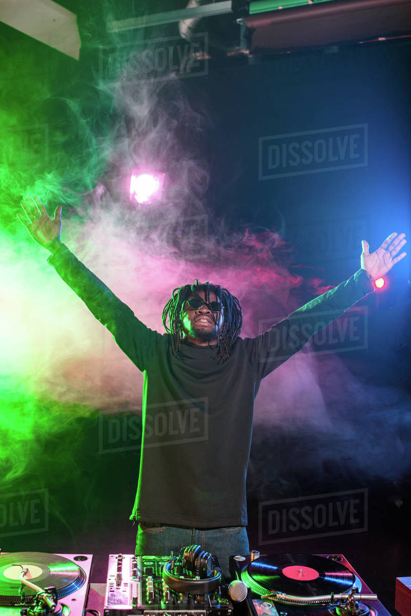 Professional African American dj with sound mixer in nightclub ...