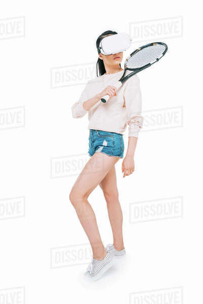 Attractive young Asian woman in virtual reality headset holding tennis ...