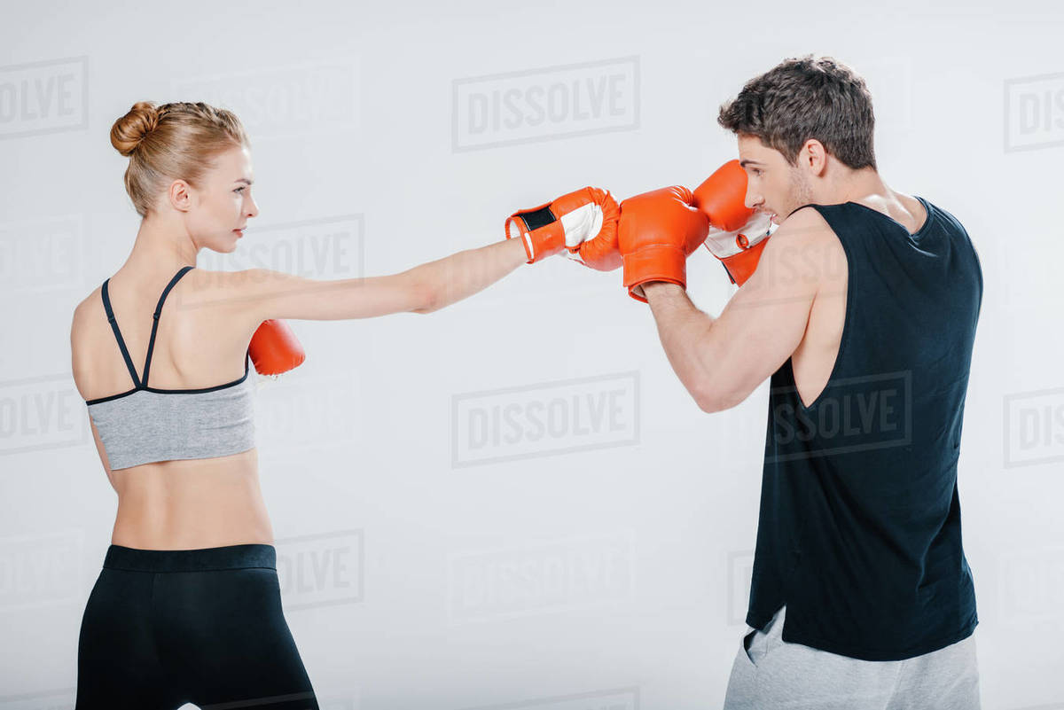 Young couple boxing isolated on white - Royalty-free Stock Photo | Dissolve