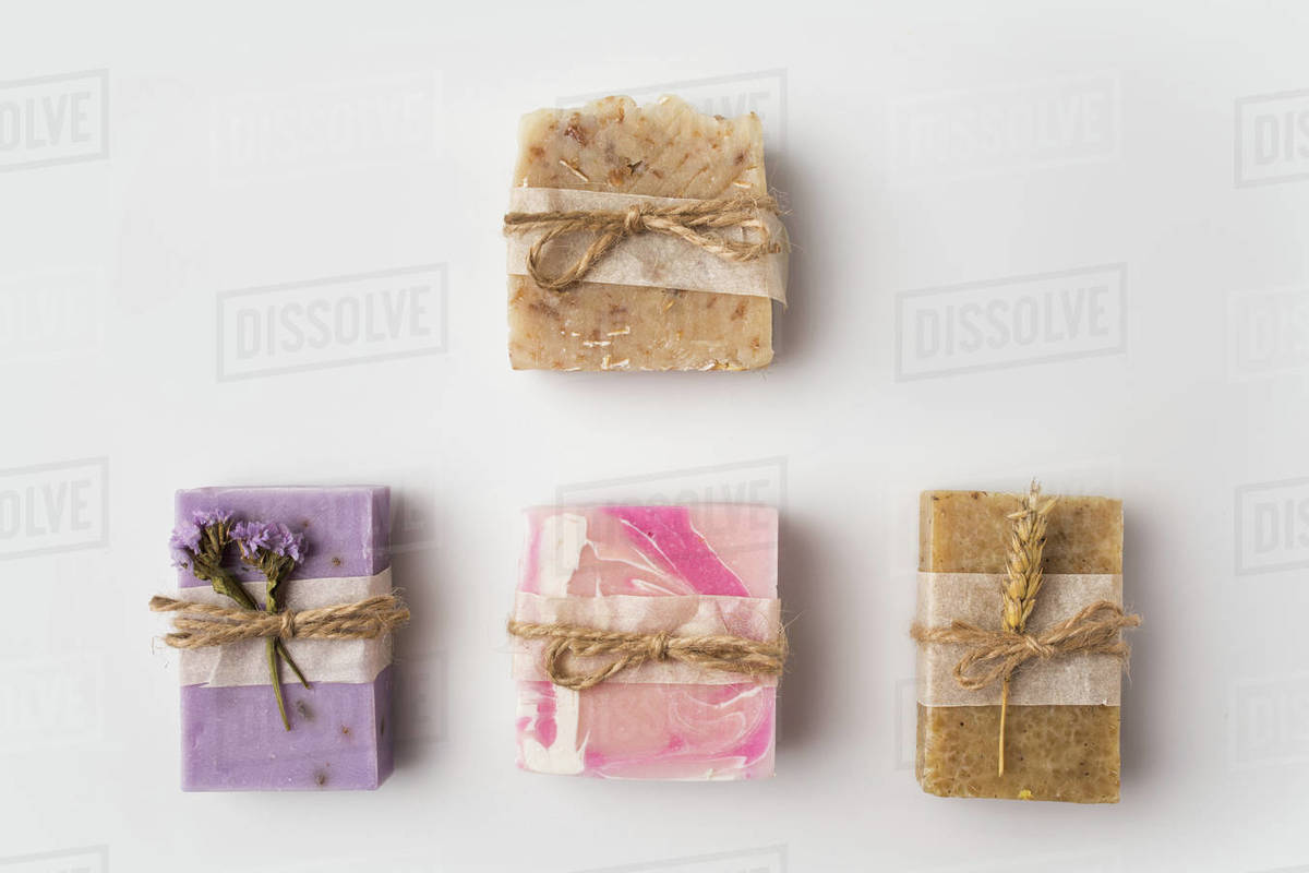 top view of different decorated homemade soap on white surface - Stock ...
