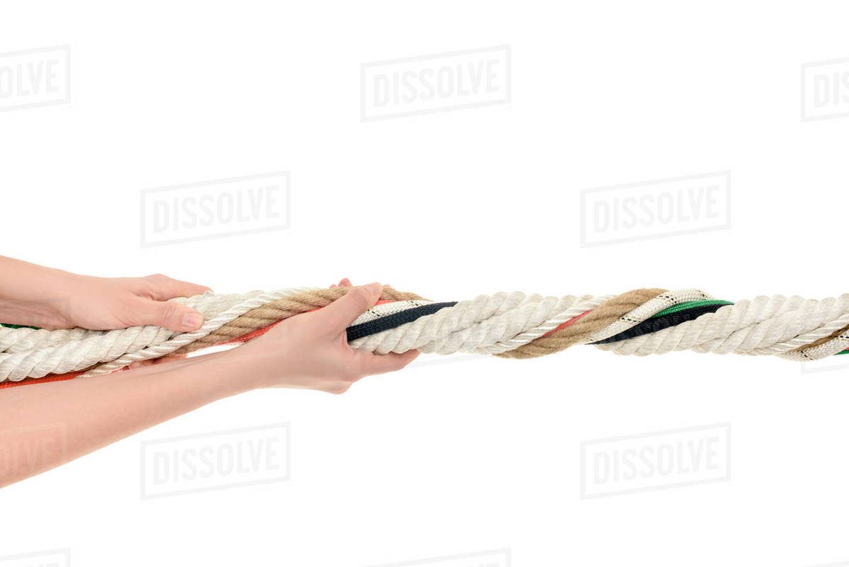 Close-up partial view of human hands holding twisted ropes isolated on ...