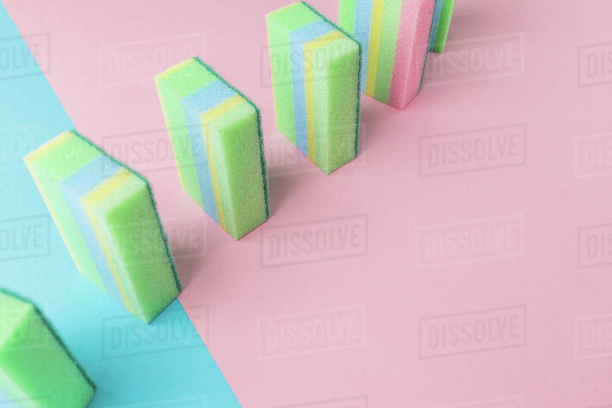 Line of colorful washing kitchen sponges, on blue and pink - Stock ...