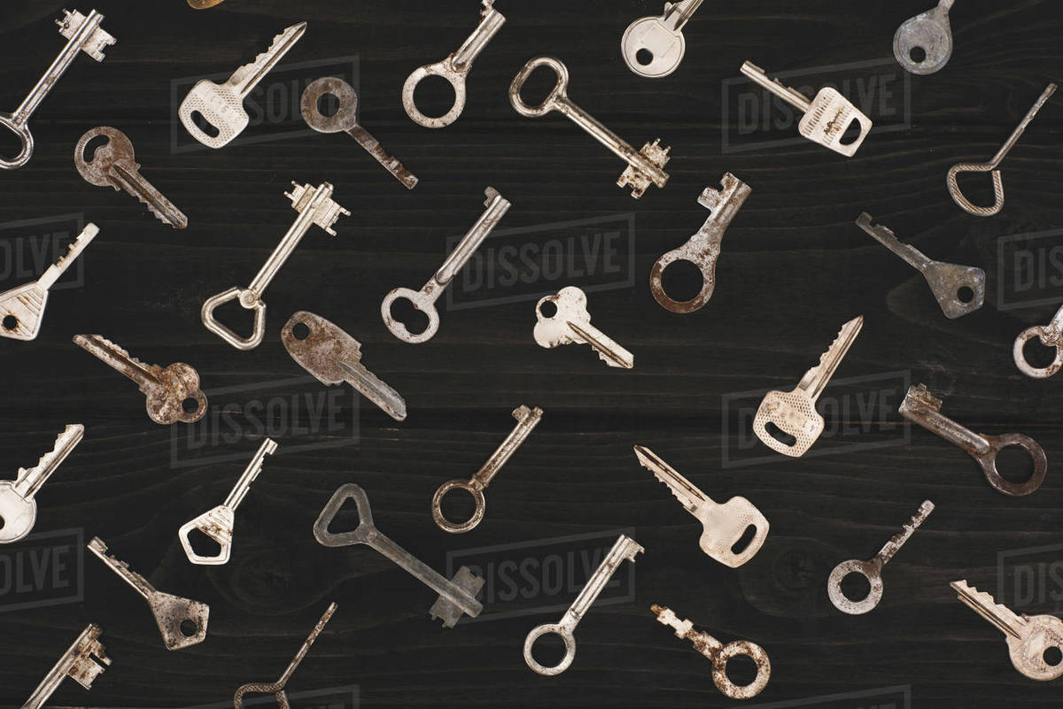 top view of different metal keys isolated on black - Stock Photo - Dissolve