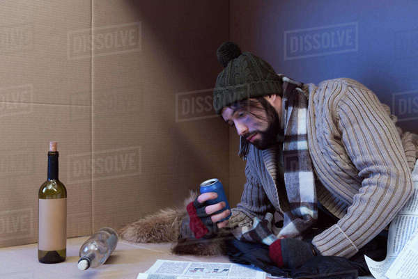 Homeless man with alcohol drinks in cardboard box - Royalty-free Stock ...