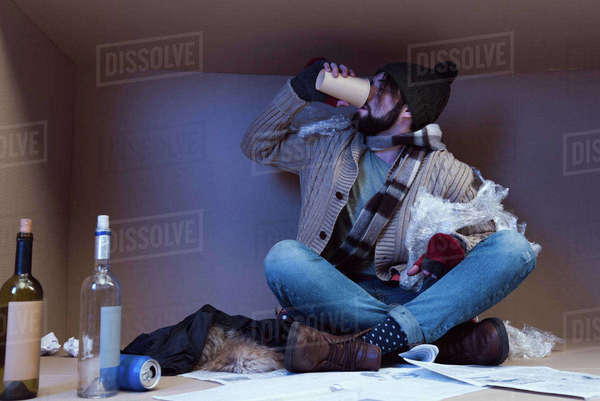 Homeless man drinking alcohol in cardboard box - Royalty-free Stock ...