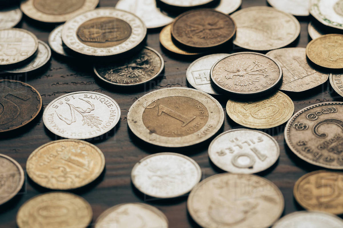 Close up on collection of coins on wooden tabletop - Royalty-free Stock ...