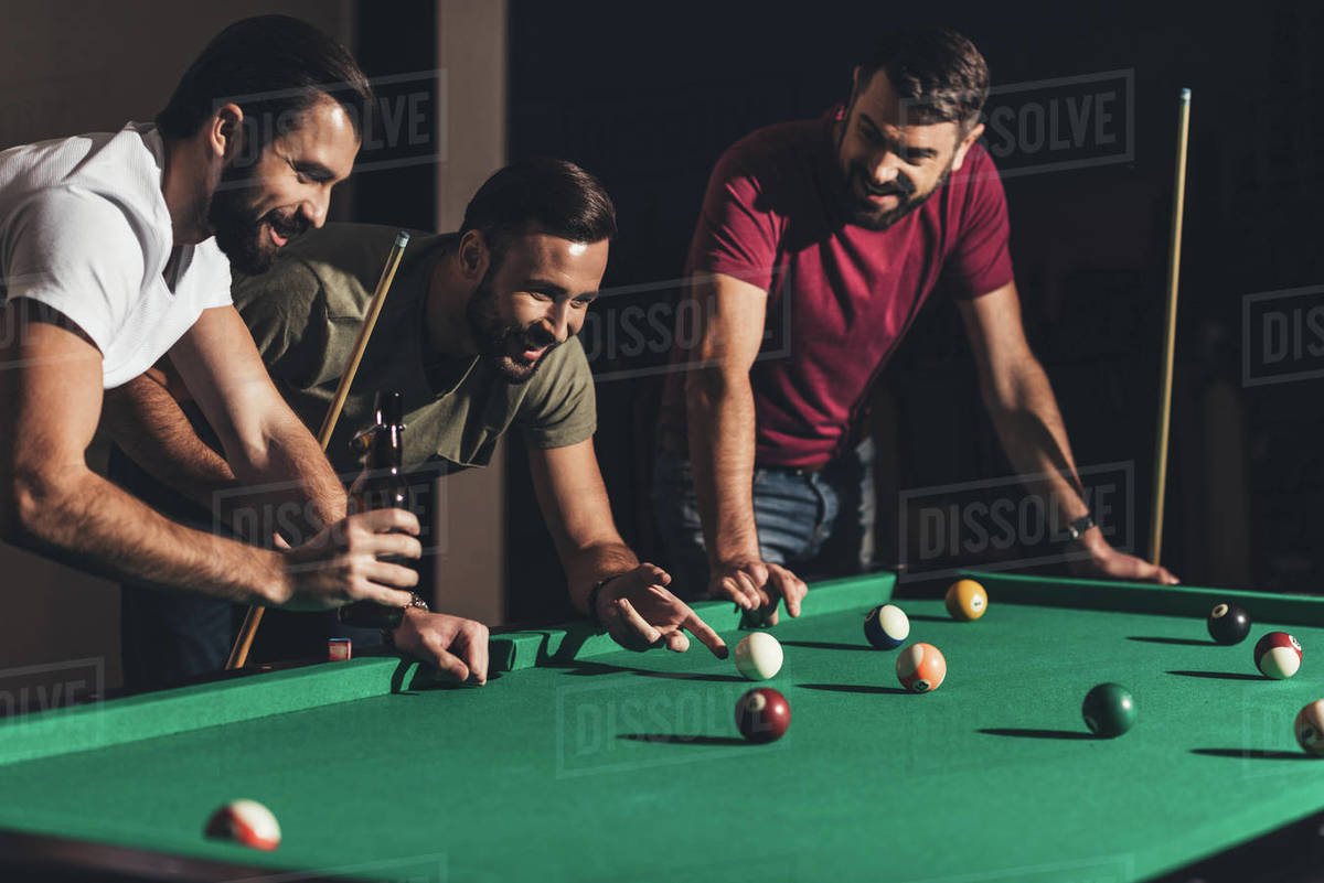 Group of young handsome men playing in pool at bar - Royalty-free Stock ...