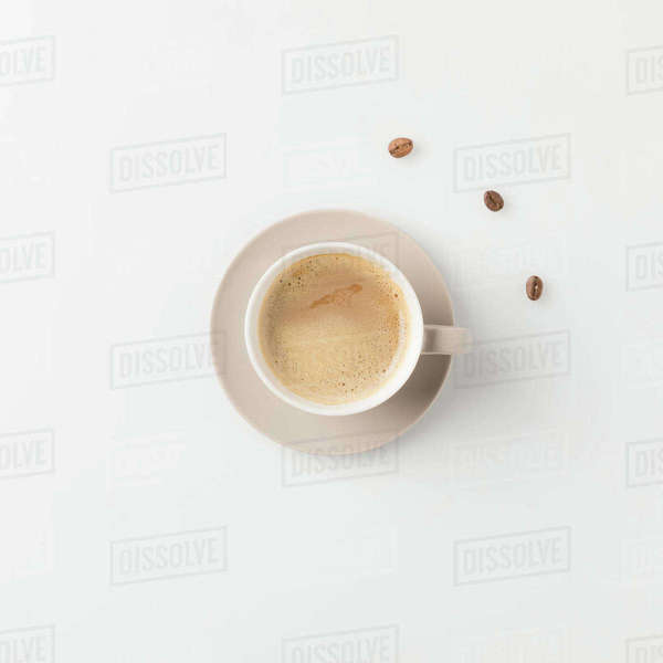 Top view of coffee cup with beans on white surface - Royalty-free Stock ...