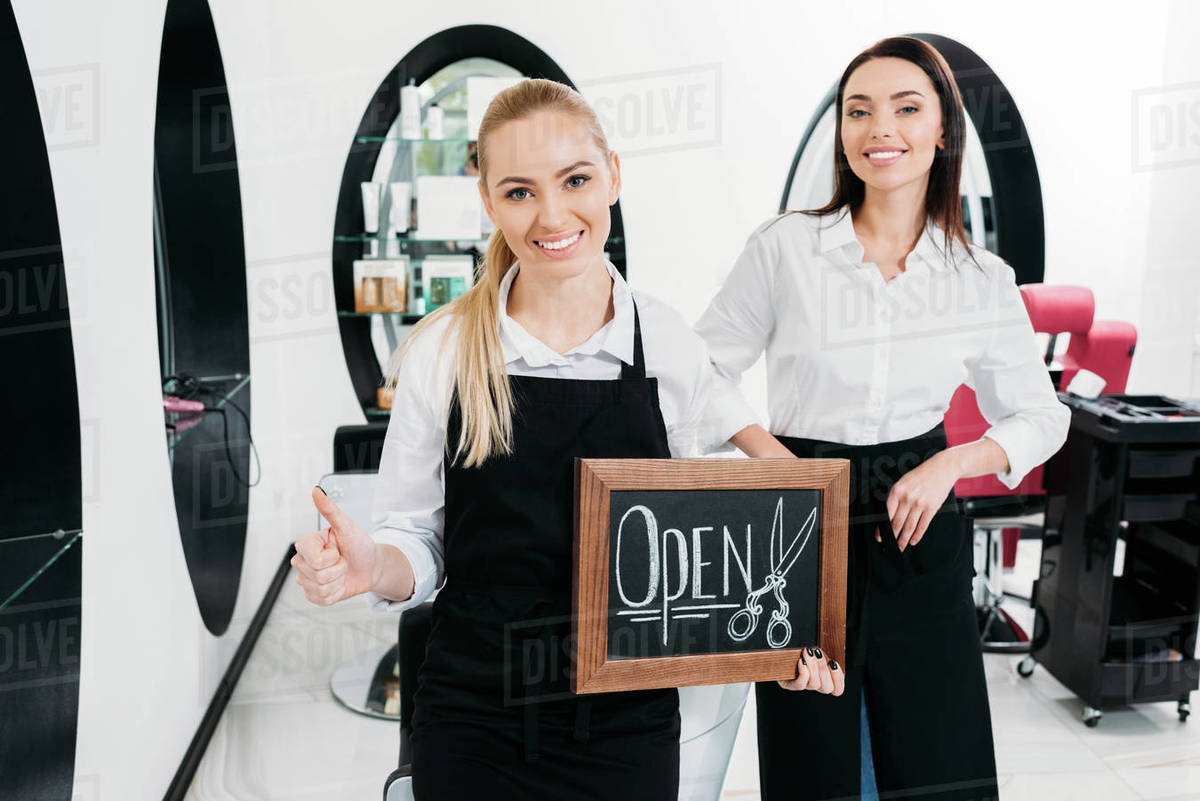 Hairdresser holding signboard open and showing thumb up - Royalty-free ...