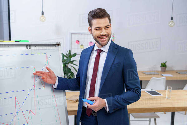 Smiling businessman pointing on diagram chart - Royalty-free Stock ...