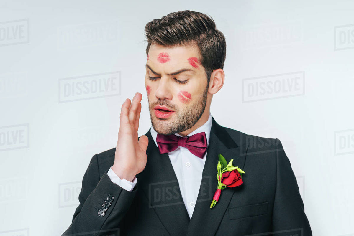 Portrait of handsome groom in suit with red lipstick on face - Royalty ...
