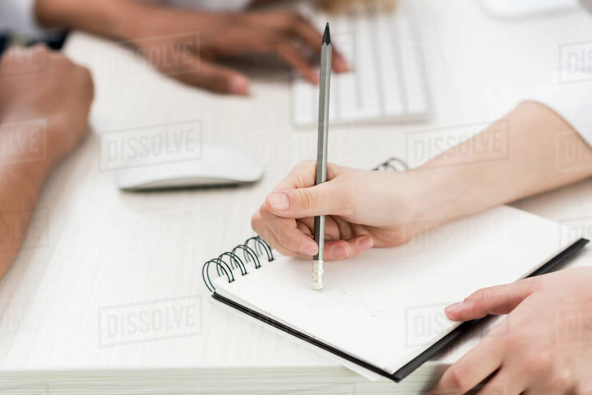 Cropped shot of students doing task together during lesson - Royalty ...