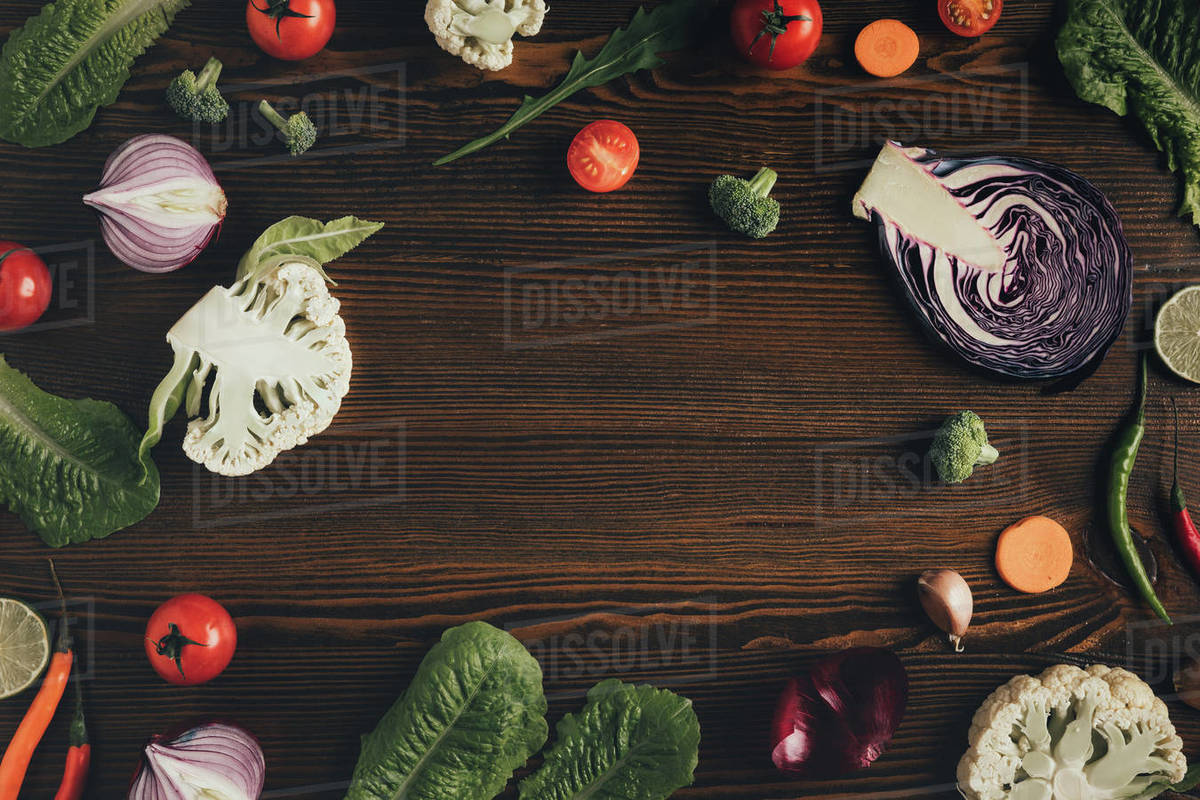 Top view of different vegetables on grungy surface - Stock Photo - Dissolve