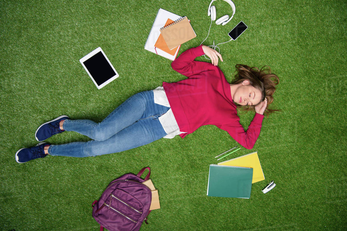 Overhead view of young student sleeping on green lawn - Royalty-free ...
