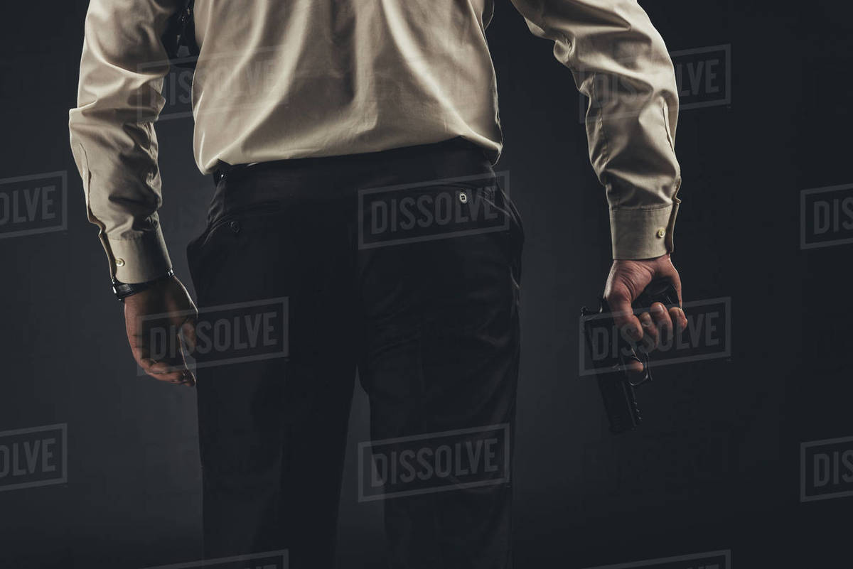 Cropped shot of man holding gun in hand - Royalty-free Stock Photo ...
